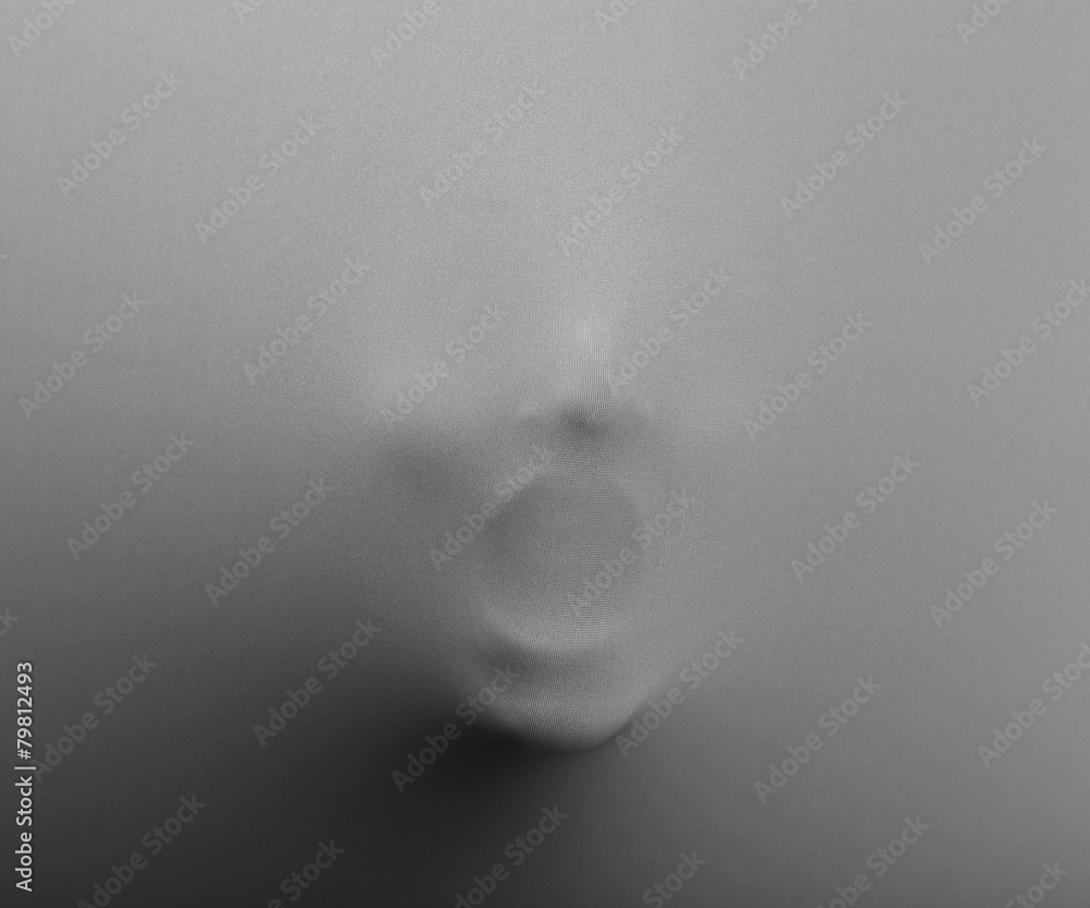Screaming human face pressing through fabric as horror Stock Photo ...