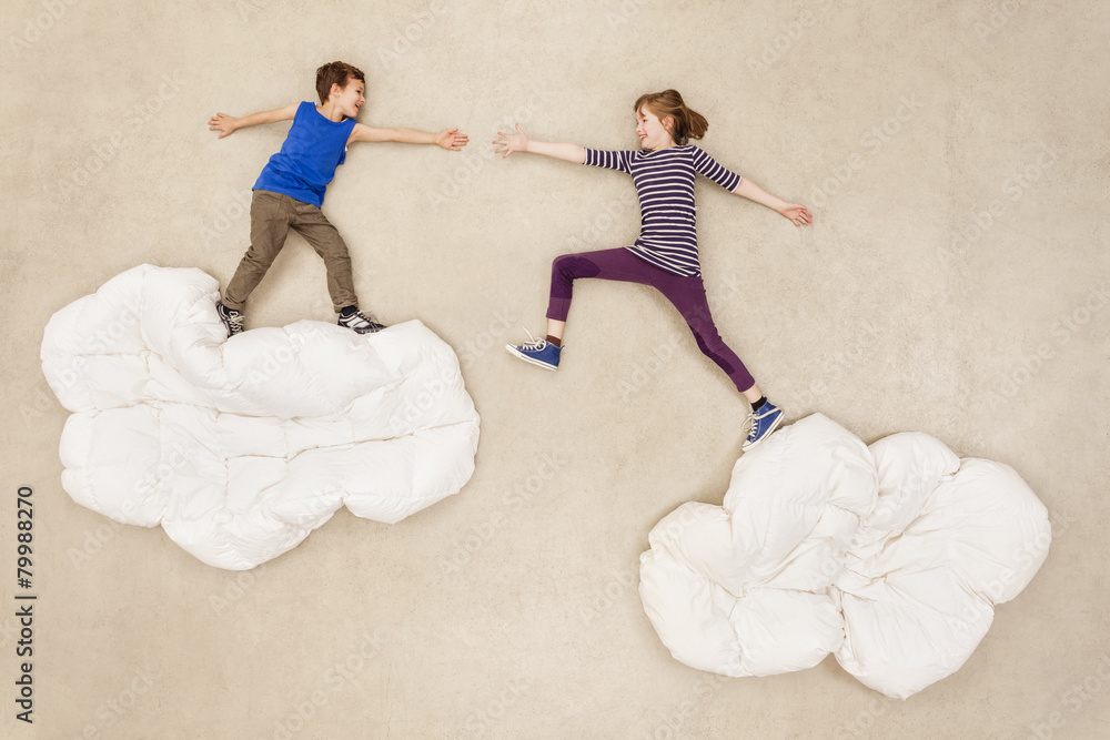 Foto Stock Children jumping over clouds | Adobe Stock