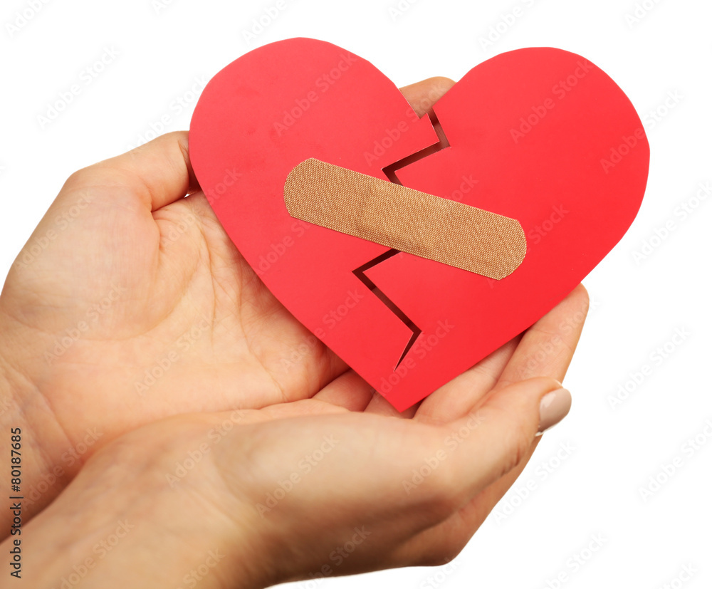Female hands holding broken heart with plaster isolated on Stock Photo ...