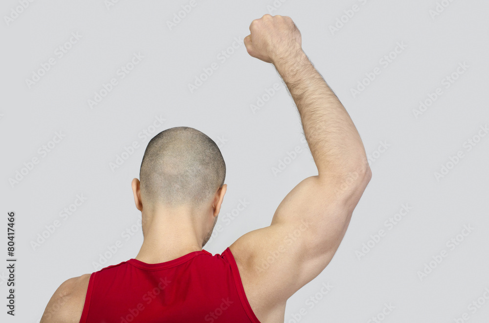Bodybuilder from back raising his arm and fist. Man protesting. Stock ...