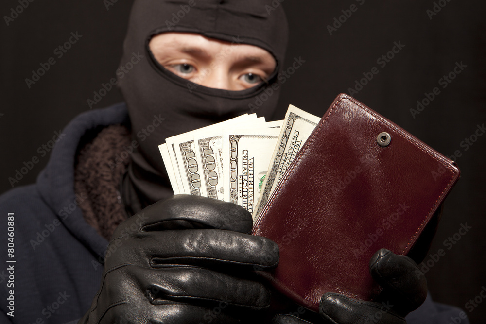 Thief with a purse Stock Photo | Adobe Stock