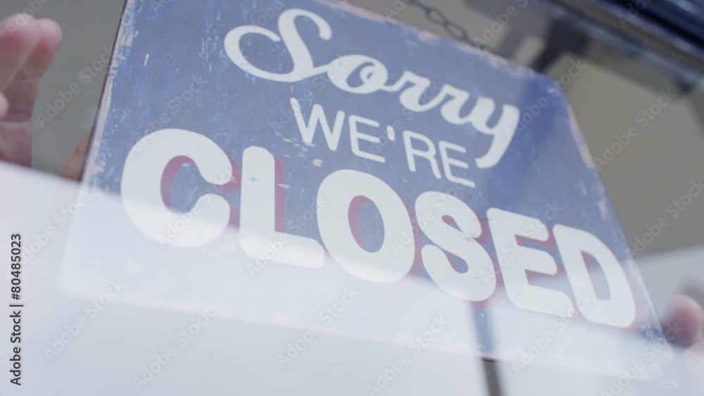 'Closed' sign is turned to 'Open' in a storefront window Stock ビデオ ...