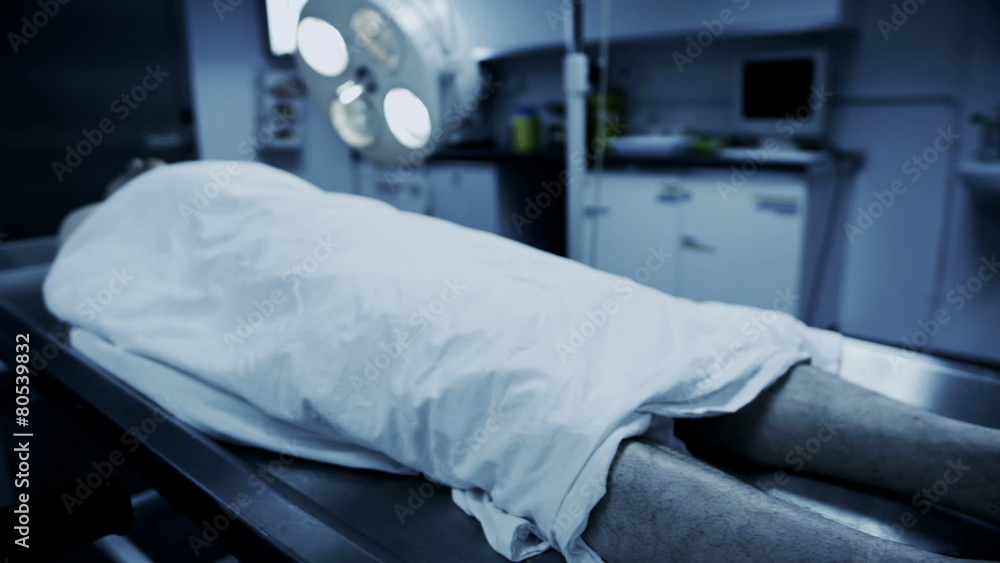 Dead male body laid out on an autopsy table comes back to life Stock ...