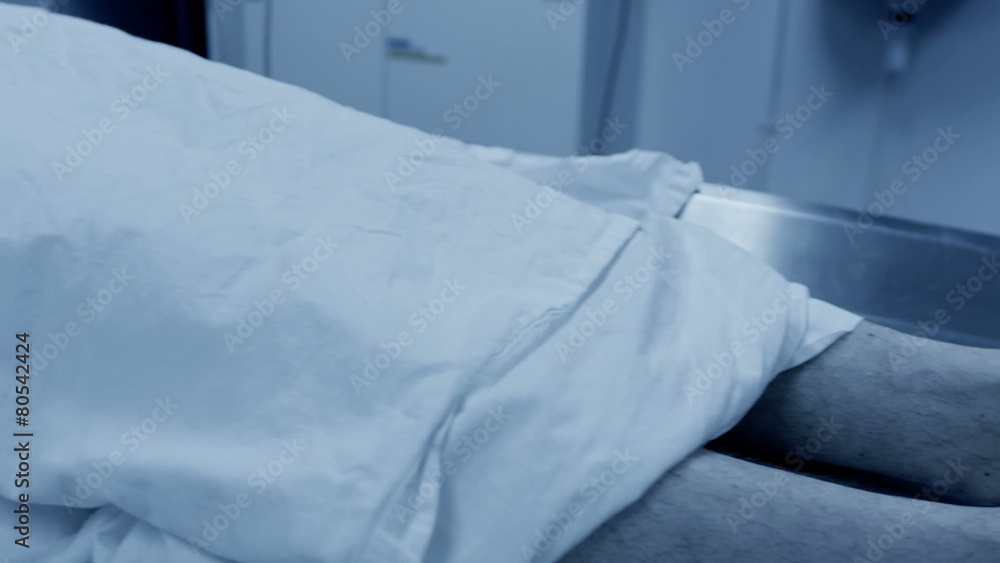 Smoking kills! Dead male body laid out on autopsy table with cigarette ...