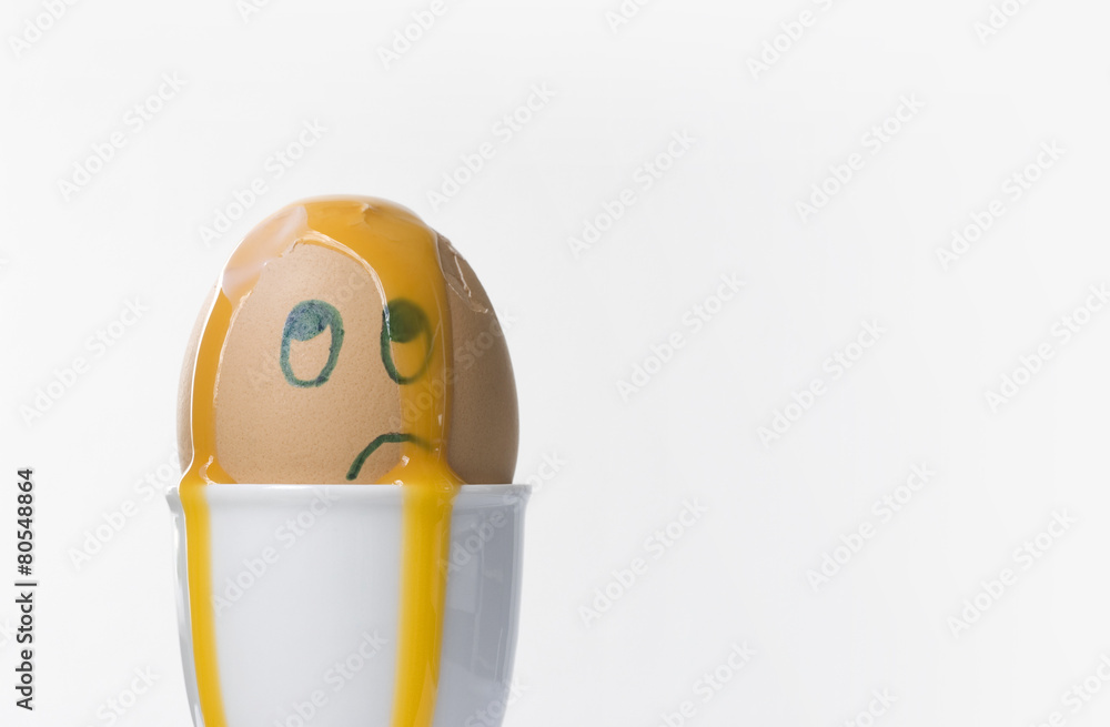 Boiled egg in cup cracked open yolk running down unhappy face drawing ...