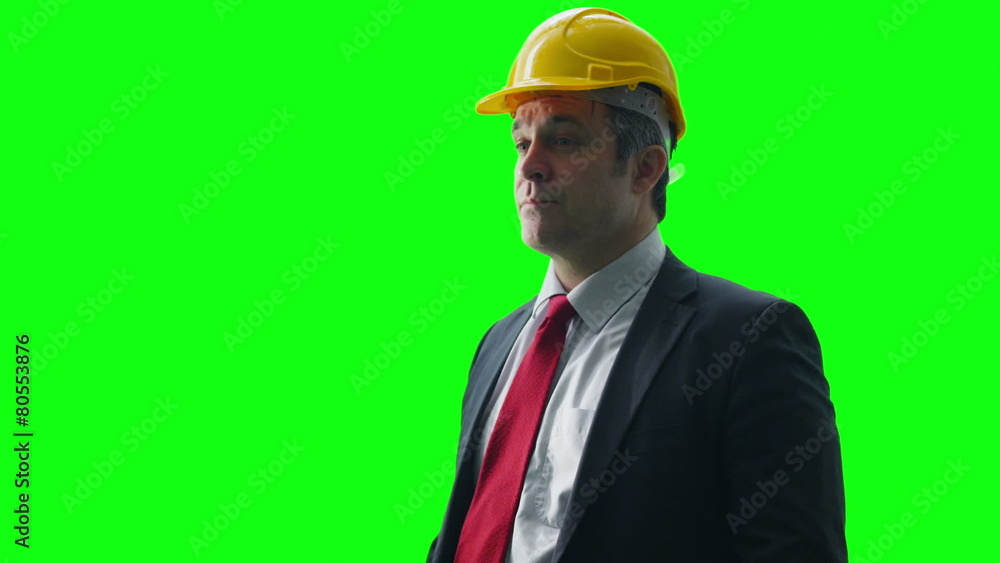 Portrait of businessman wearing a hard hat on green screen background ...