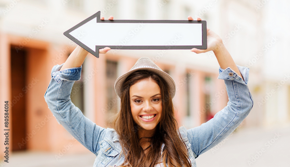 girl showing direction with arrow in the city Stock Photo | Adobe Stock