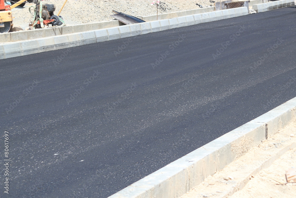 New road under construction. Tarmac being laid on a new road with an ...