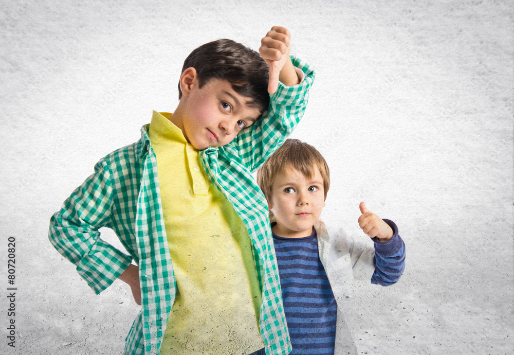 Kids making good and bad sign over white background Stock Photo | Adobe ...