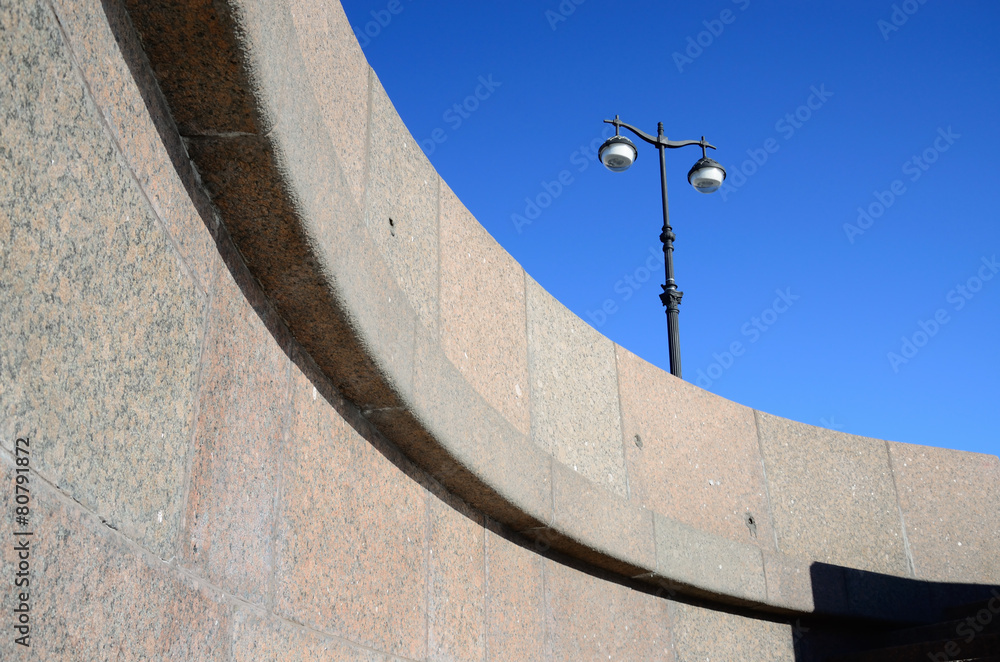 Curved parapet and a light against the blue sky Stock Photo | Adobe Stock