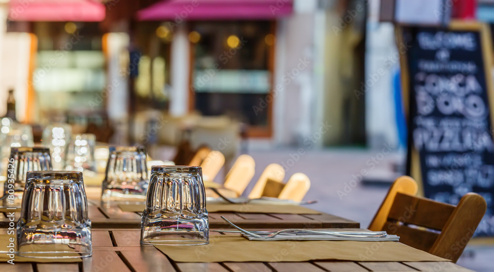 Restaurant table with glasses and menu in the background Stock Photo ...
