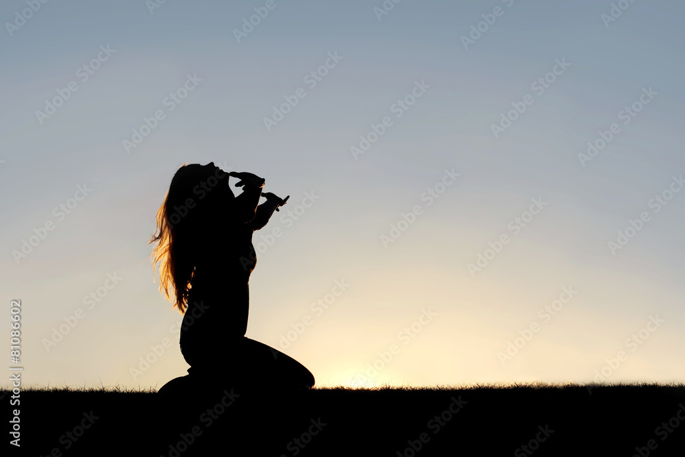 Silhouette of Woman Kneeling in Prayer and Surrender Stock Photo ...