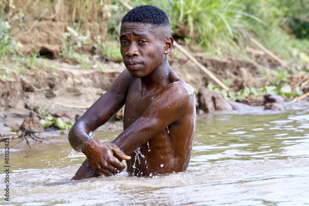African poor man taking a bath in river, Madagascar Stock Photo | Adobe ...