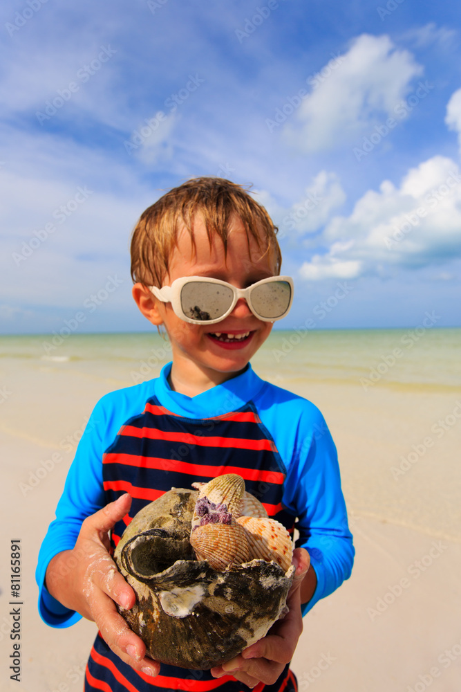little boy holding seashells on summer tropical beach Stock Photo ...