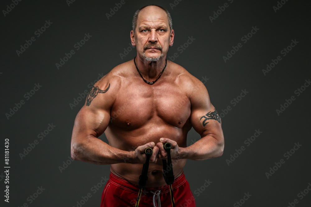 Muscular middle age man showing his muscules Stock Photo | Adobe Stock