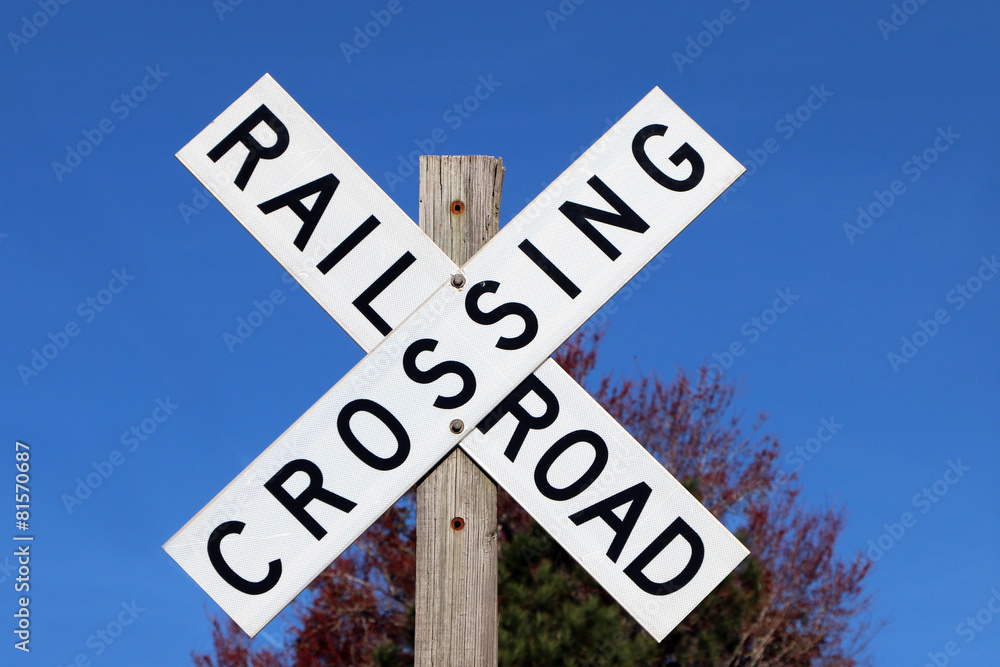 Railroad crossing sign against blue sky background Stock Photo | Adobe ...