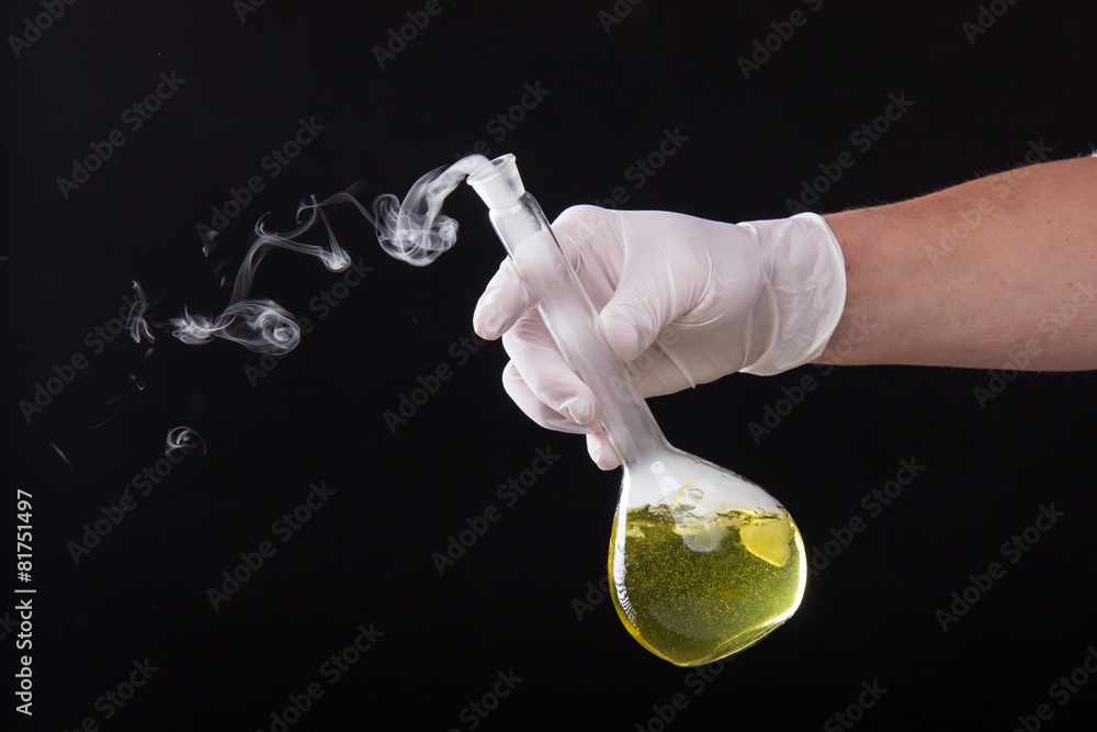 Chemical reaction in volumetric flask glass kept in the hands of Stock ...