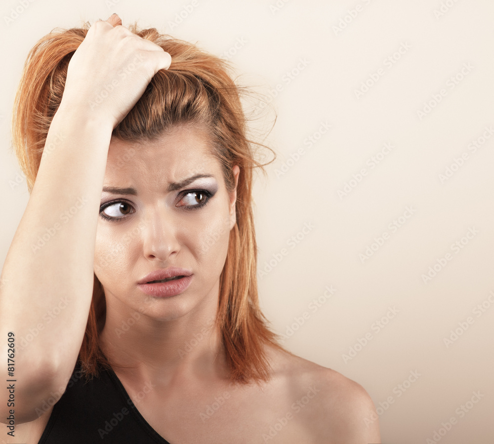 Studio shot of a beautiful worried young woman. Stock Photo | Adobe Stock