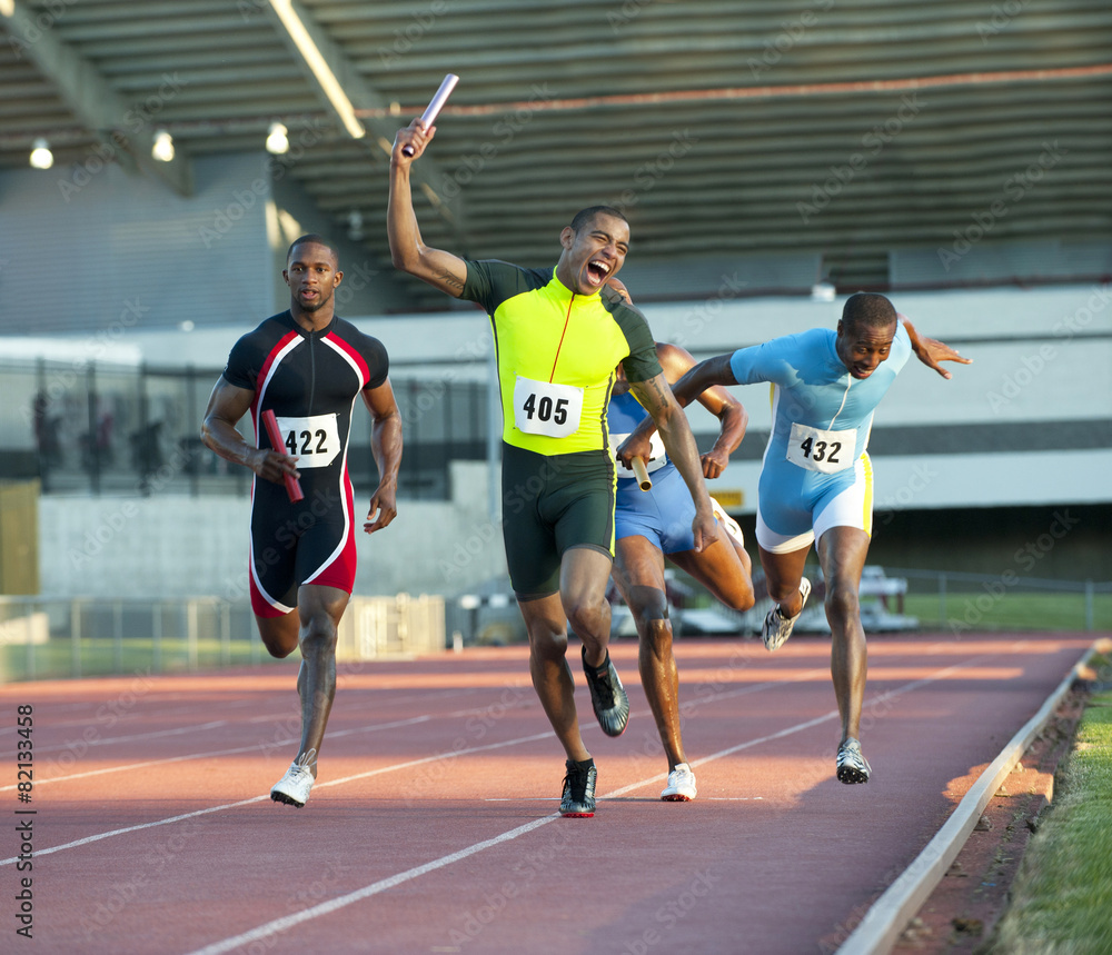 Relay racer crossing finish line on track in race Stock Photo | Adobe Stock