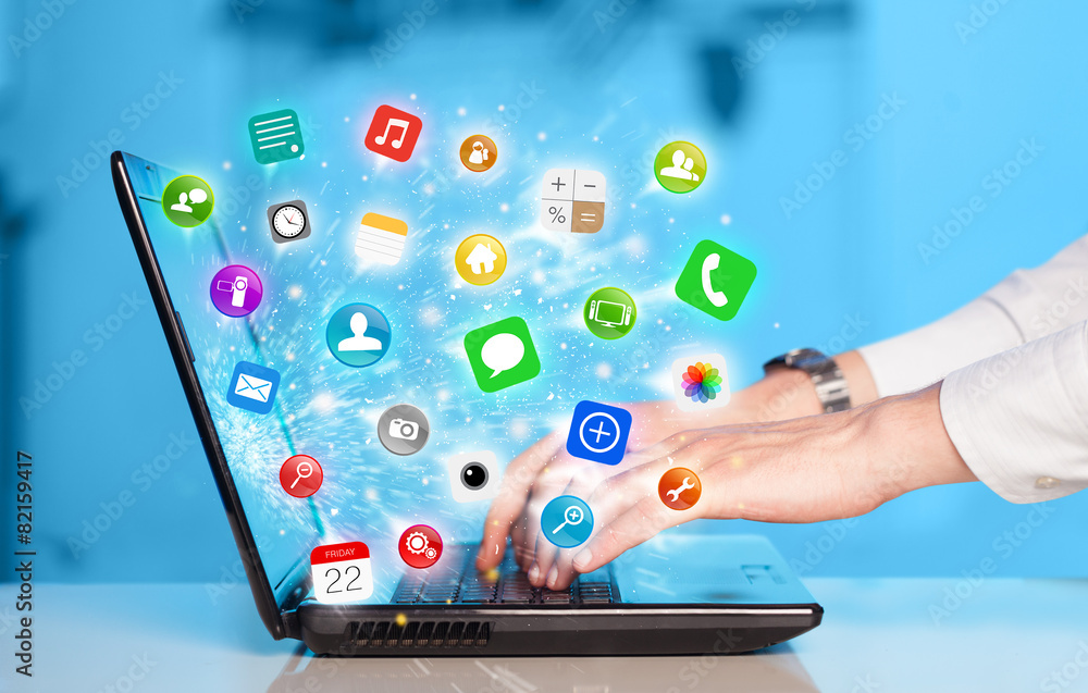 Hand pressing modern laptop with mobile app icons and symbols Stock ...