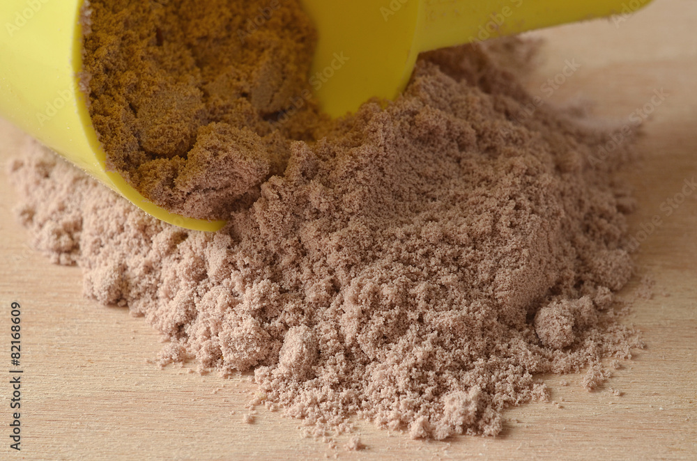 Chocolate protein powder spilled from yellow scoop Stock Photo | Adobe ...