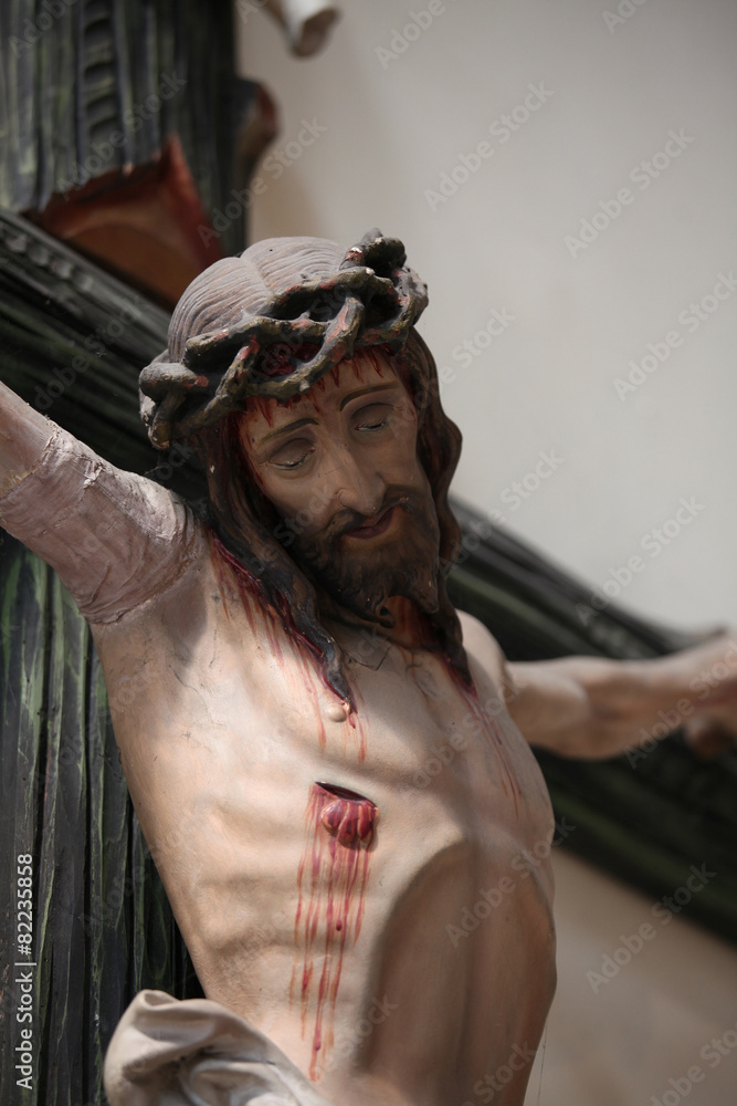 Jesus on the cross - statue in a church Stock Photo | Adobe Stock