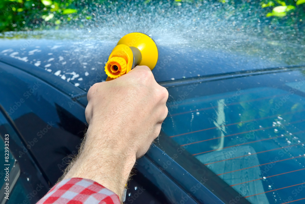 Car Care - Man washing a car using a garden spray gun Stock Photo ...