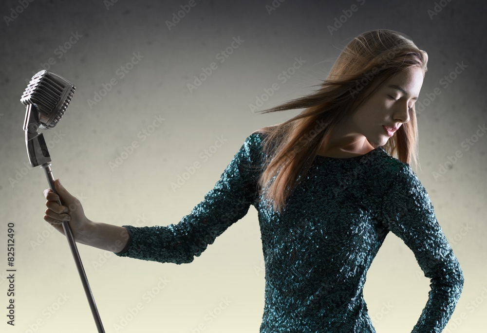 Singer. Female singer on the stage holding a microphone Stock Photo ...