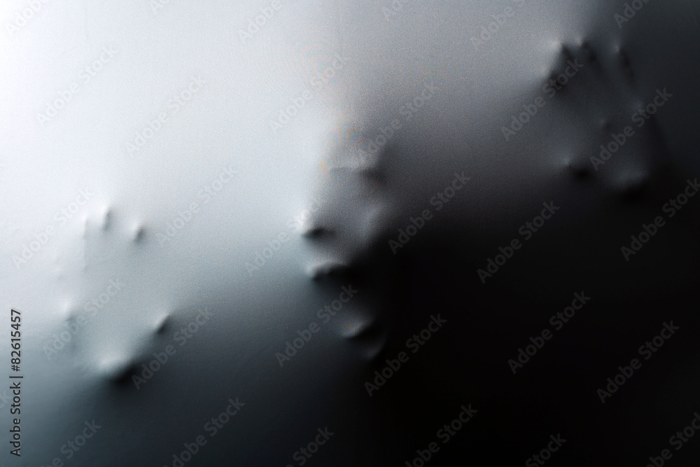 Screaming human face with hands pressing through fabric as horror ...