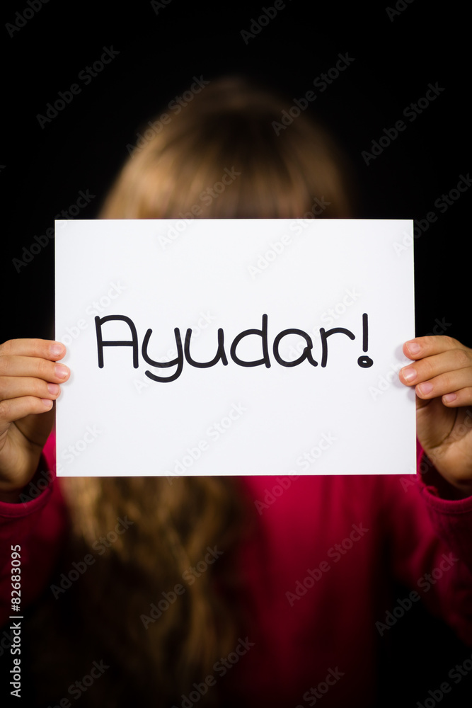 Child holding sign with Spanish word Ayudar - Help Stock Photo | Adobe ...