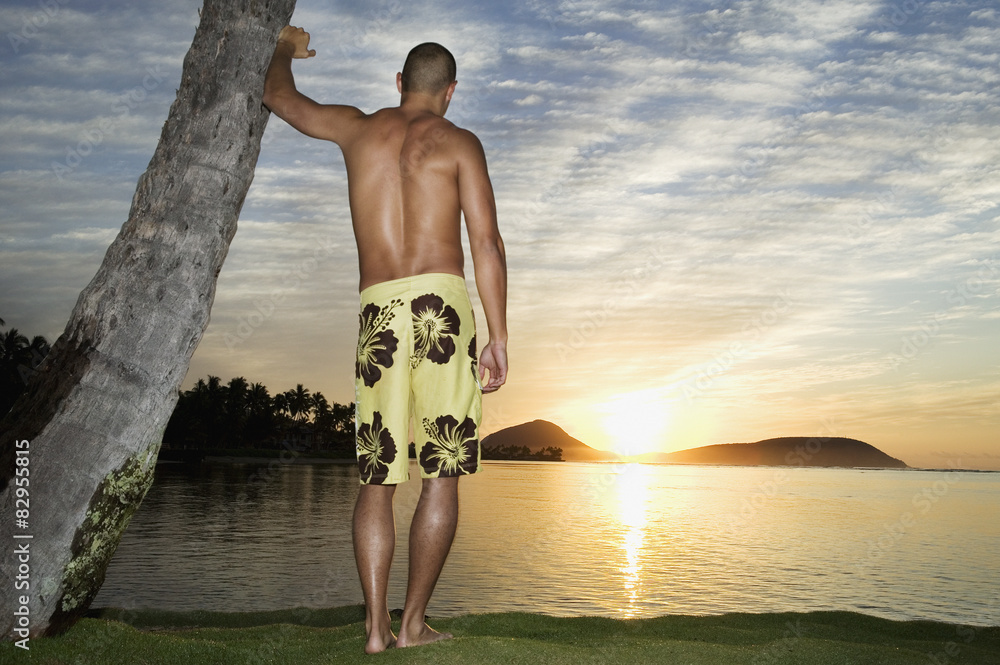 Asian man watching sunset Stock Photo | Adobe Stock