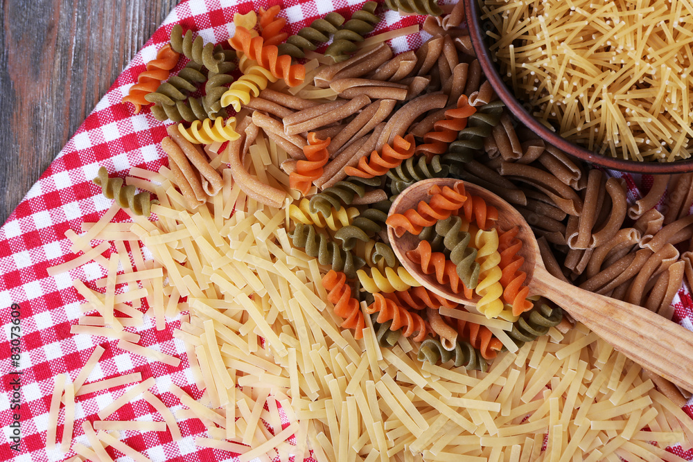 Different types of pasta on napkin on wooden background Stock Photo ...
