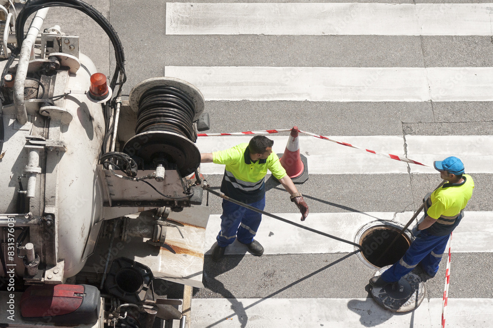 workers moves the manhole cover to check the sewer line Stock Photo ...