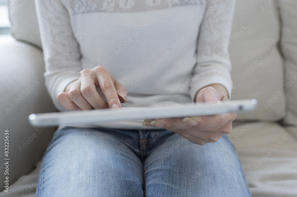 Women who are using the tablet sitting on the sofa Stock Photo | Adobe ...