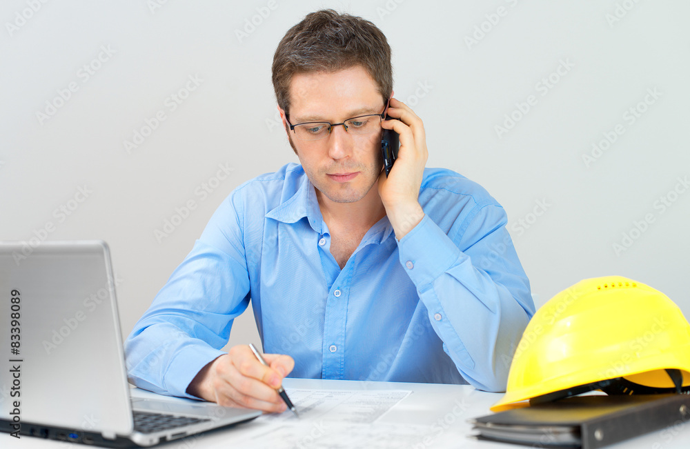 Architect discussing house plan with client by mobile phone. Stock ...