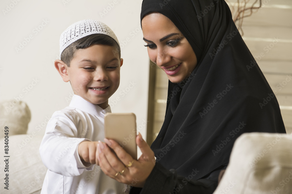 Arabian family, Arabian mother and son using mobile phone Stock Photo ...