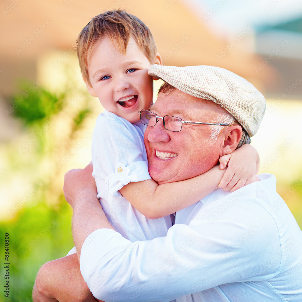 portrait of happy grandpa and grandson embracing outdoors Stock Photo ...