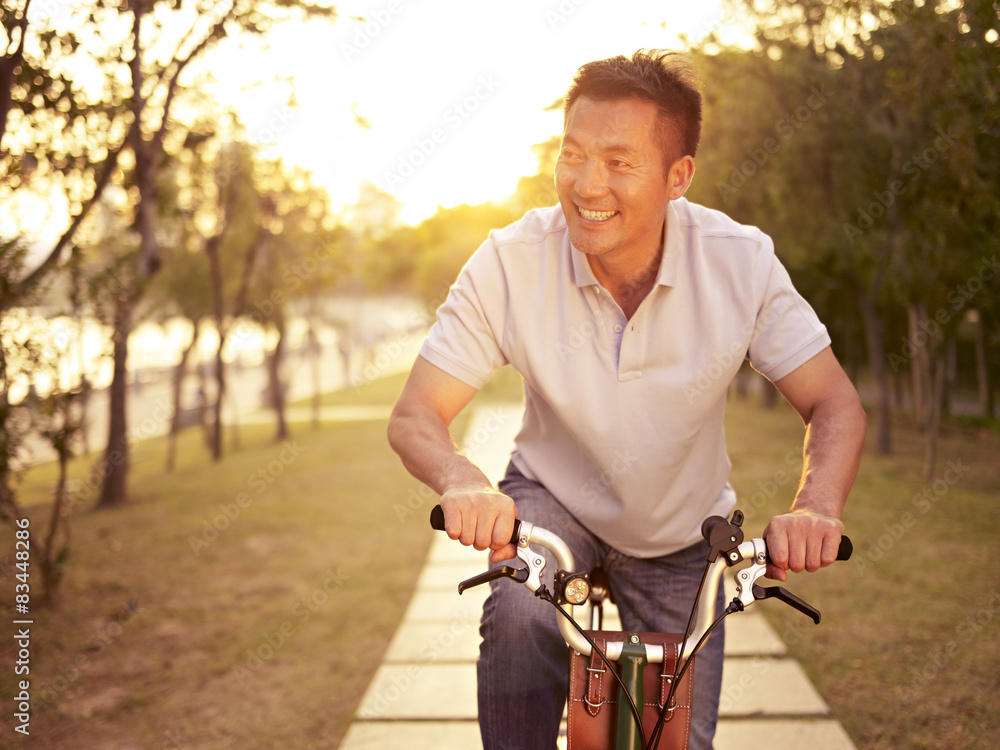 asian man enjoying bike riding outdoor in park at sunset Stock Photo ...