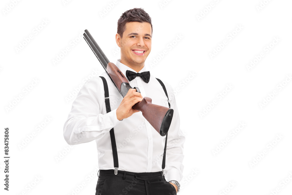 Elegant guy holding a shotgun over his shoulder isolated on whit Stock ...