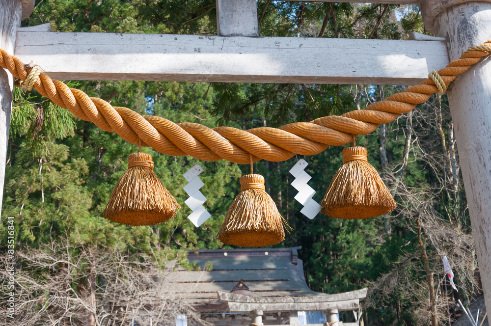 Shimenawa hang at the gate in front of the Japanese shrine Stock Photo ...