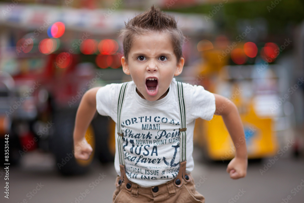 Angry boy standing outdoors Stock Photo | Adobe Stock