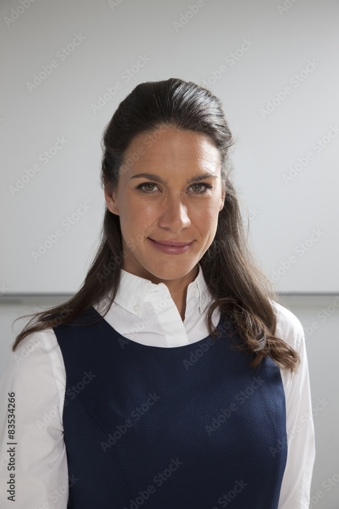 Portrait of teacher standing in front of whiteboard in classroom Stock ...