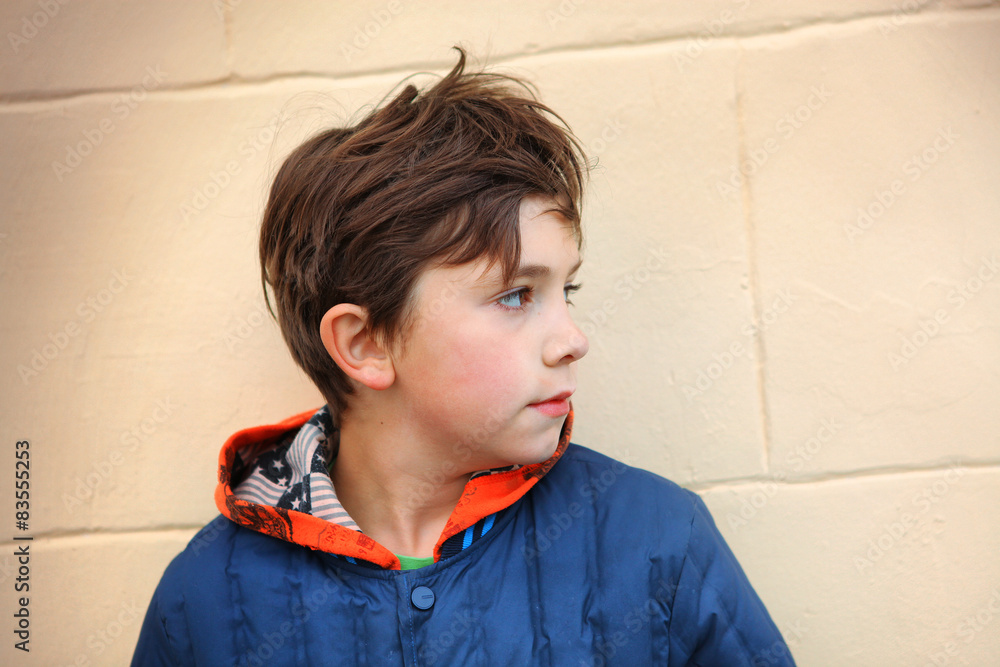 preteen handsome boy half face close up portrait on the beige wa Stock ...