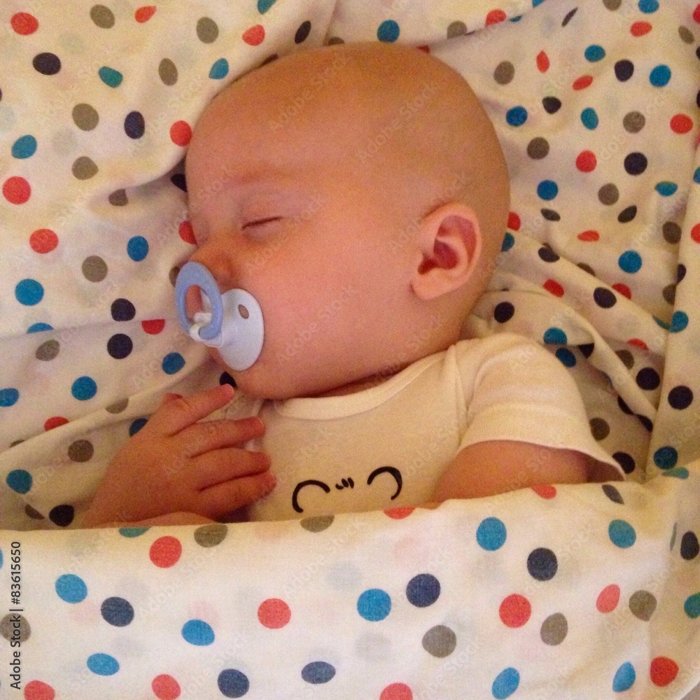 Beautiful baby taking a nap in a crib, sleeping with pacifier. Photos ...