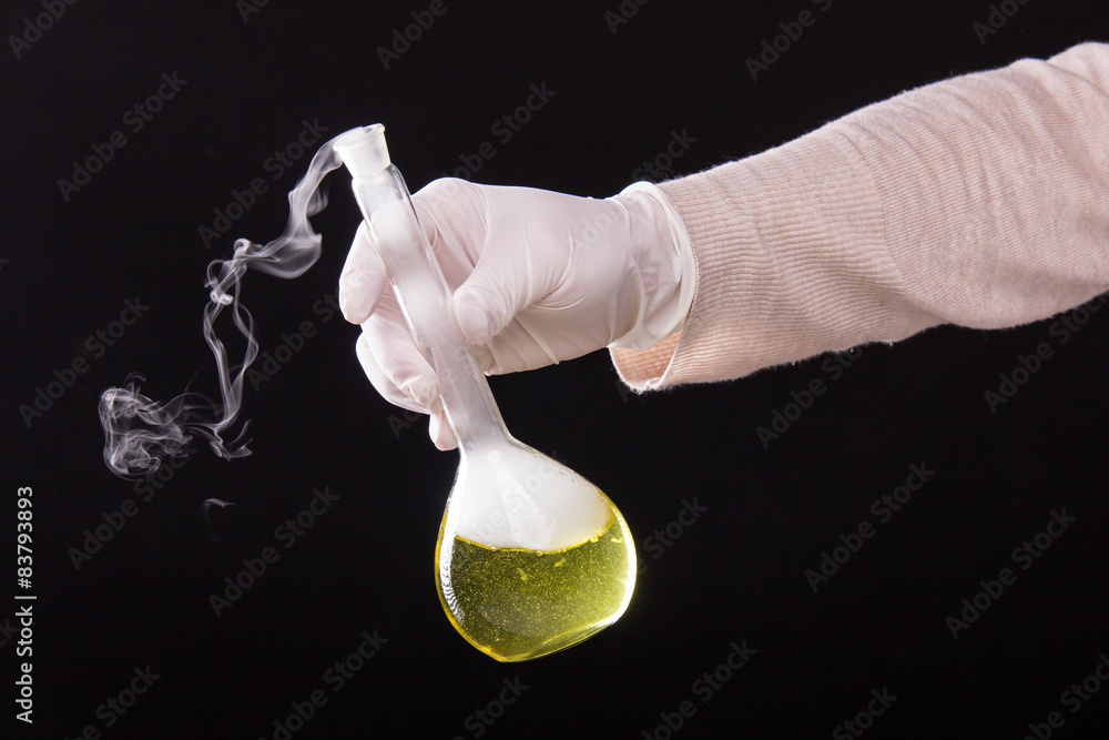 Chemical reaction in volumetric flask glass kept in the hands of Stock ...