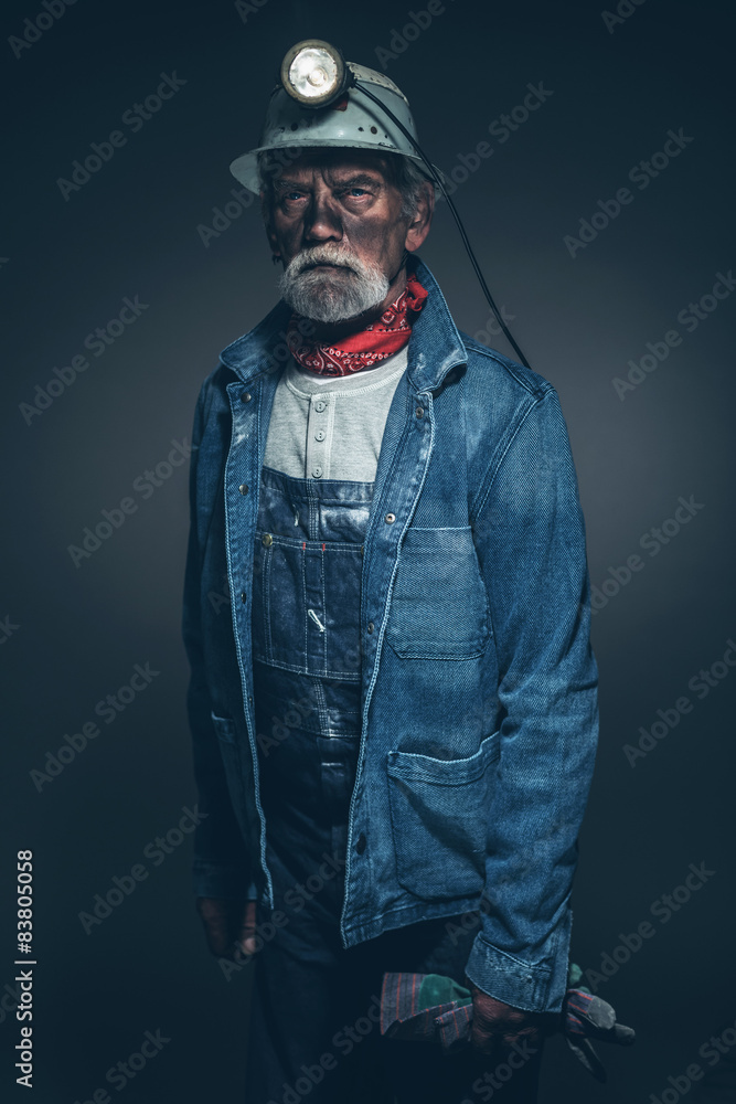 Dirty Senior Miner in Jacket Holding his Gloves Stock Photo | Adobe Stock