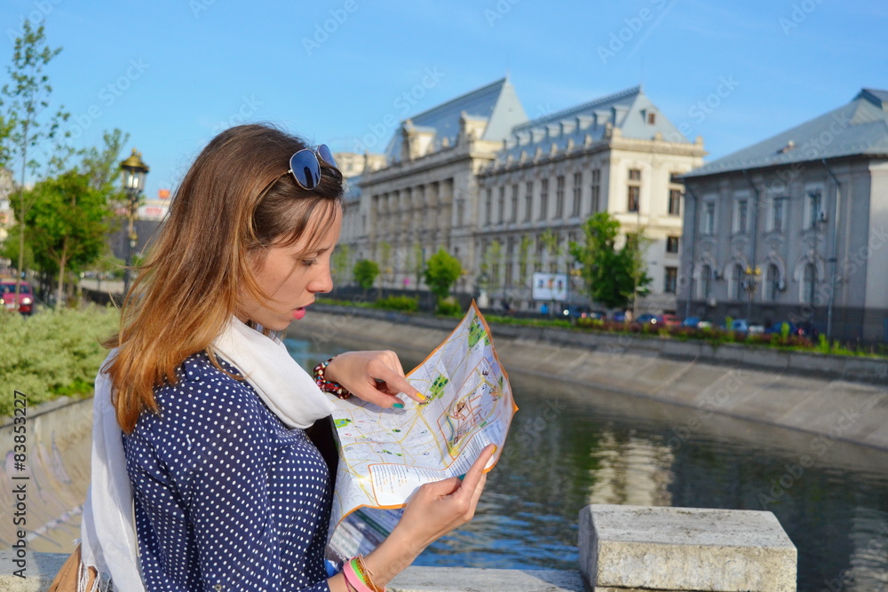 Young girl reading a map close to a river Stock Photo | Adobe Stock