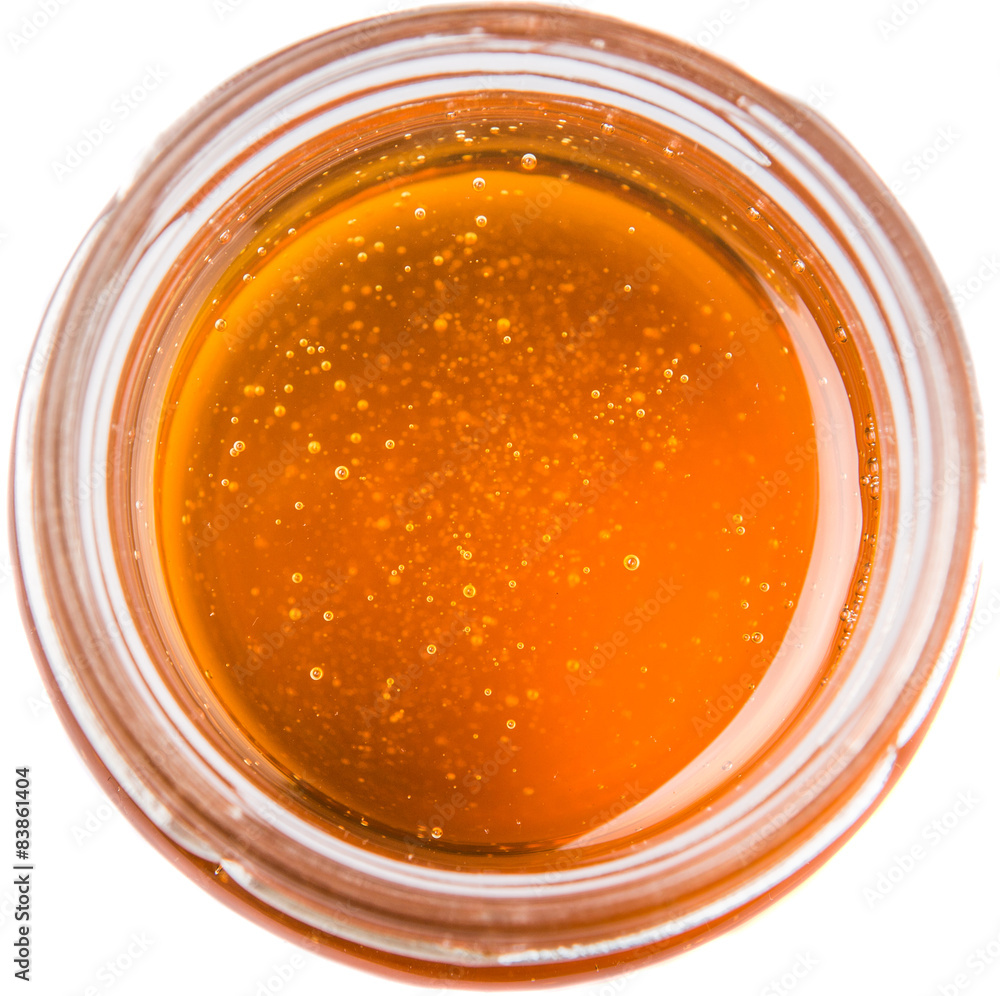 Honey in a mason jar over white background Stock Photo | Adobe Stock