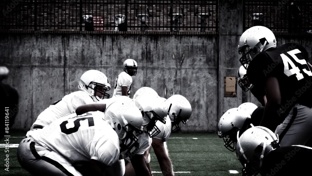 A Quarterback hikes the ball from the line of scrimmage and throws a ...