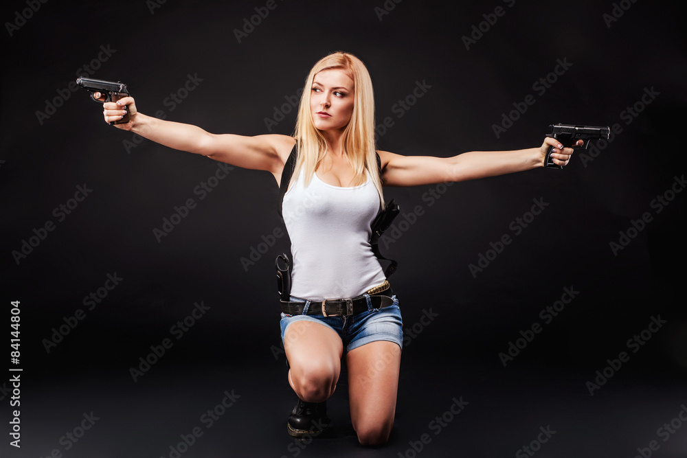 Beautiful woman with gun Stock Photo | Adobe Stock